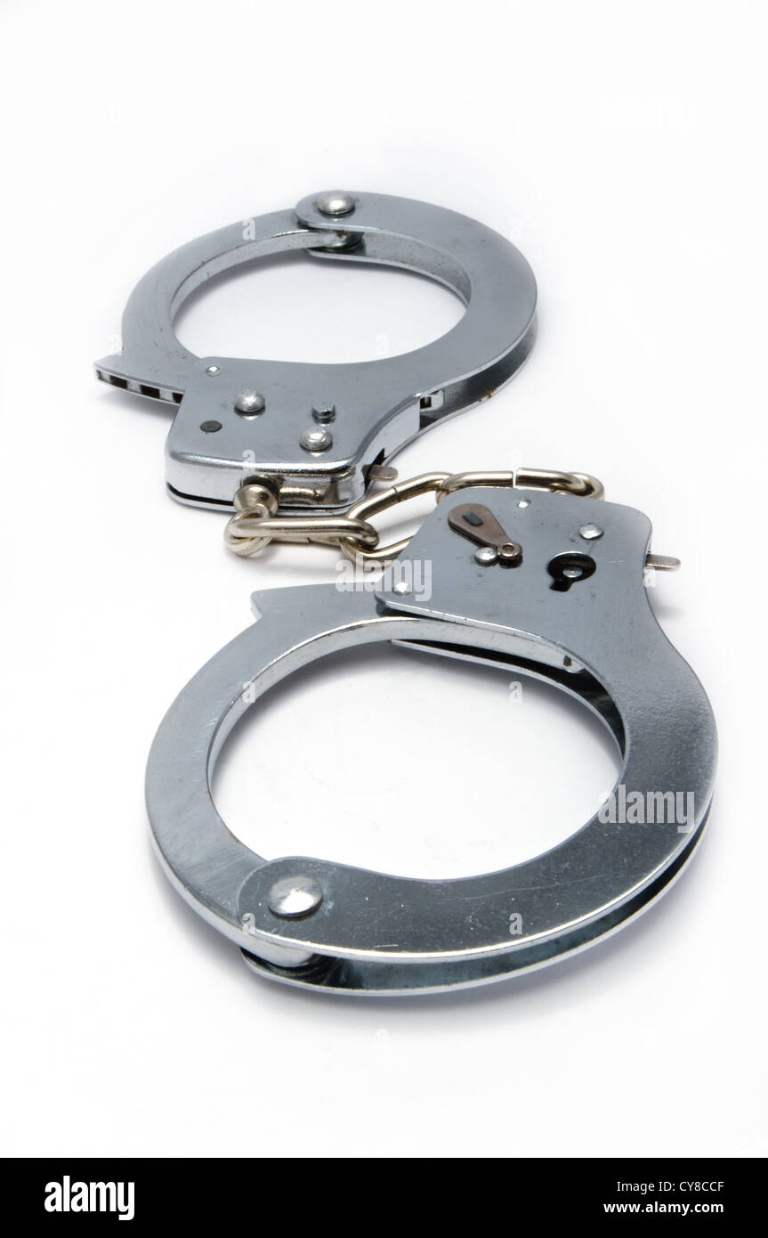 A pair of metal handcuffs isolated on a plain white background Stock ...
