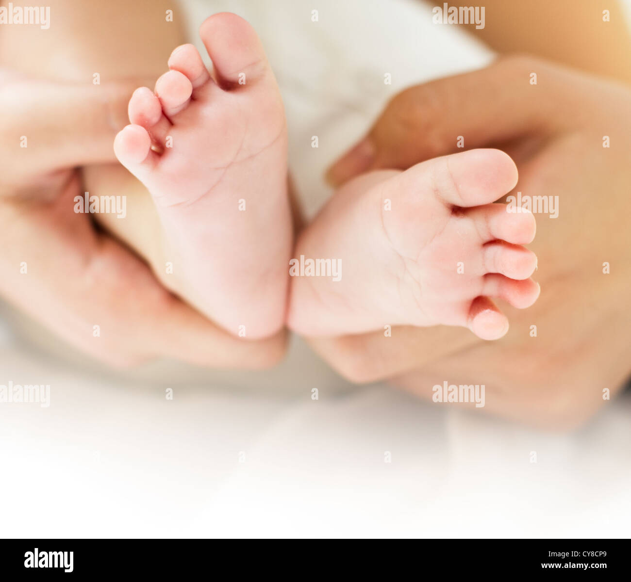Cute baby holding feet hand hi-res stock photography and images - Alamy