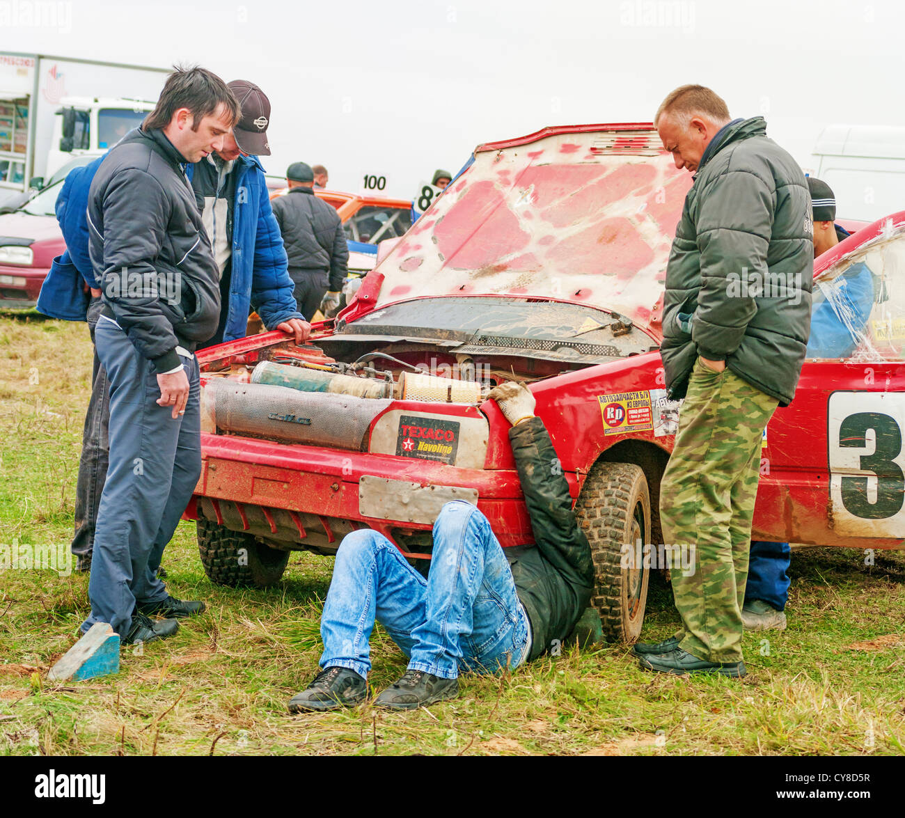 Mechanics repair the red racing car Stock Photo - Alamy