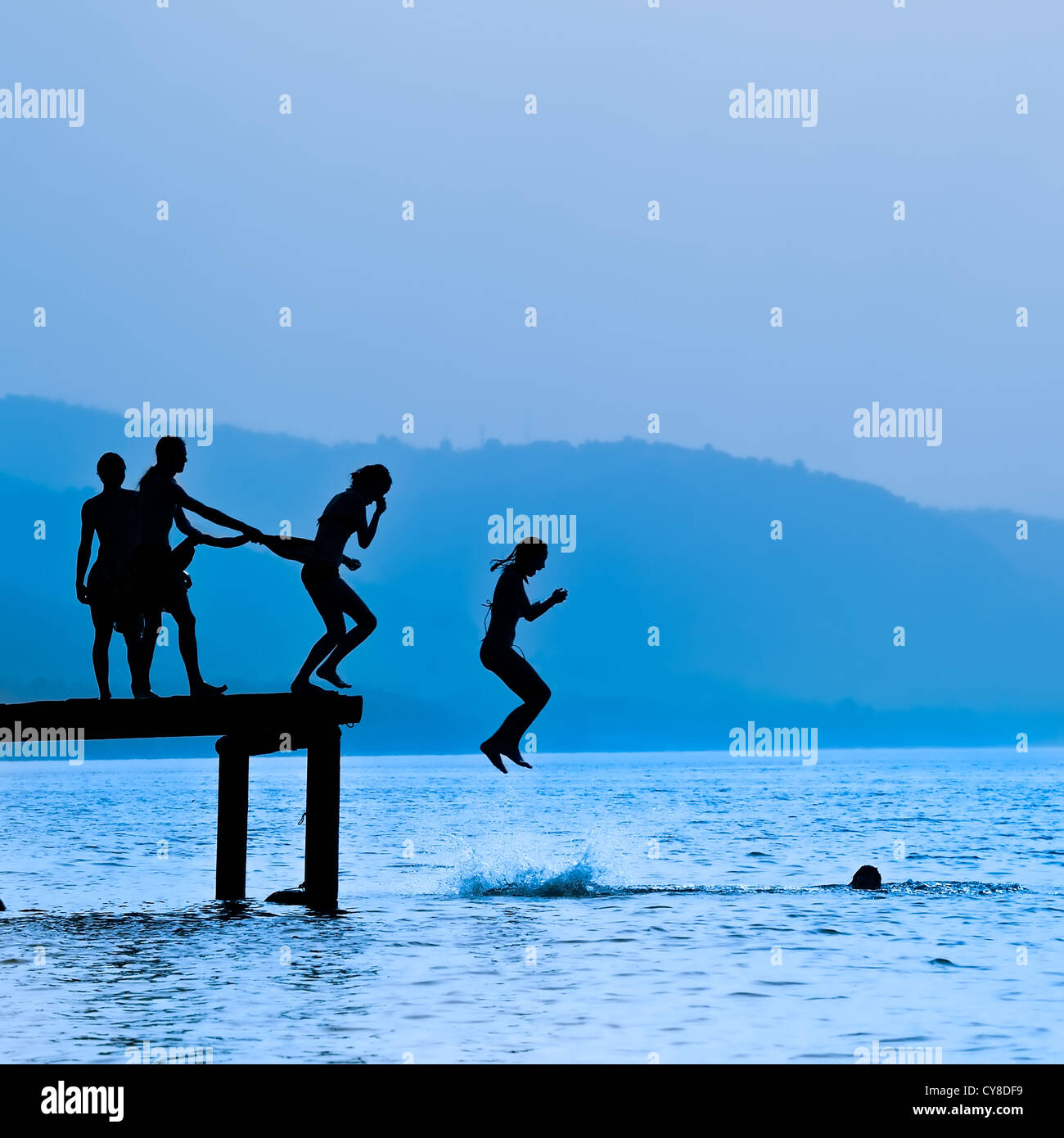 Silhouette of friends jumping in water ,sumer fun Stock Photo - Alamy
