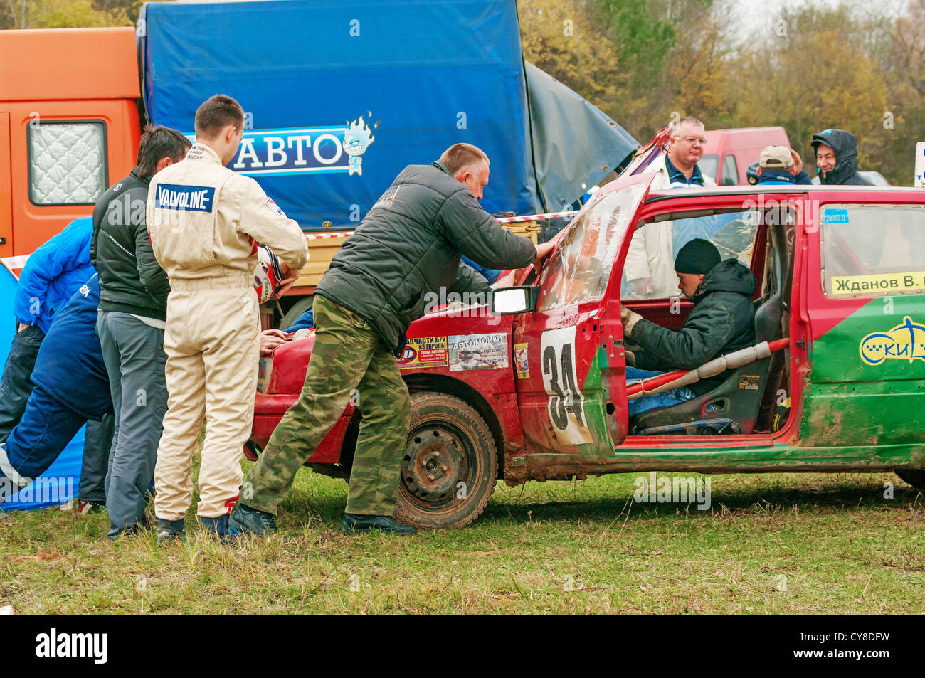 Mechanics repair the red racing car Stock Photo - Alamy
