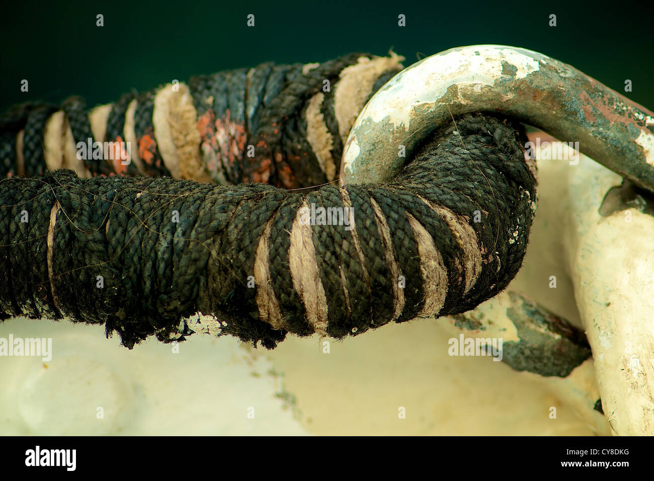 Worn rope on a ship passing through ring Stock Photo - Alamy