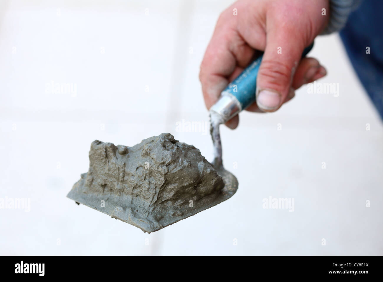 Man Construction worker is tiling at home Stock Photo - Alamy