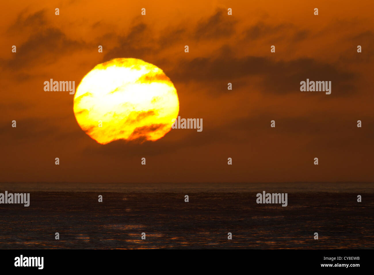 Large Sun Setting over the Pacific Ocean Stock Photo - Alamy