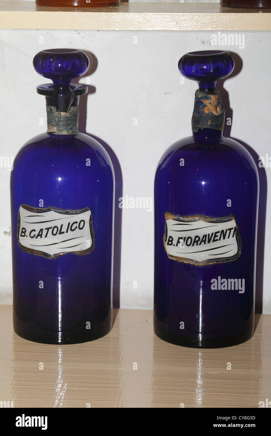 Vintage medical pharmaceutical colorful chemical bottles on the shelf ...