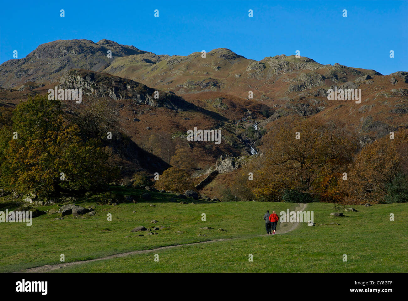 Two walkers in the Easedale valley, near Grasmere, Lake District ...