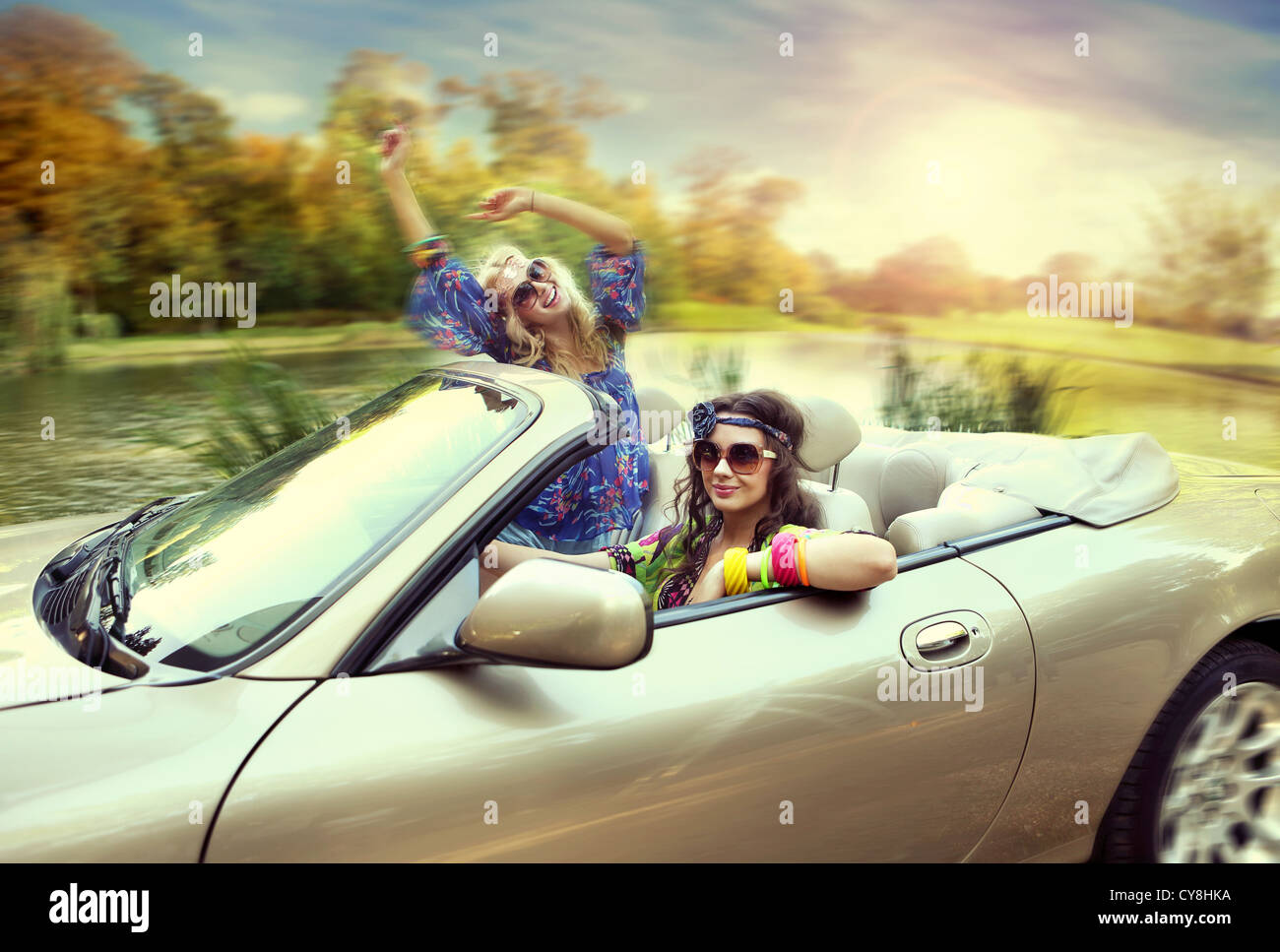 Two crazy girls in convertible Stock Photo - Alamy