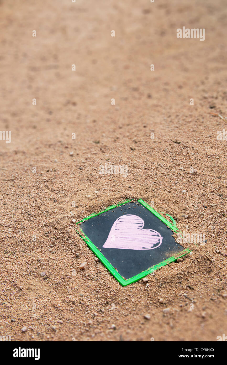 Love heart chalked on a chalkboard lying on a dusty Indian track. India ...