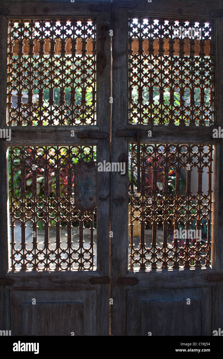 Balinese style large wooden carved doors in Bali Indonesia with metal ...