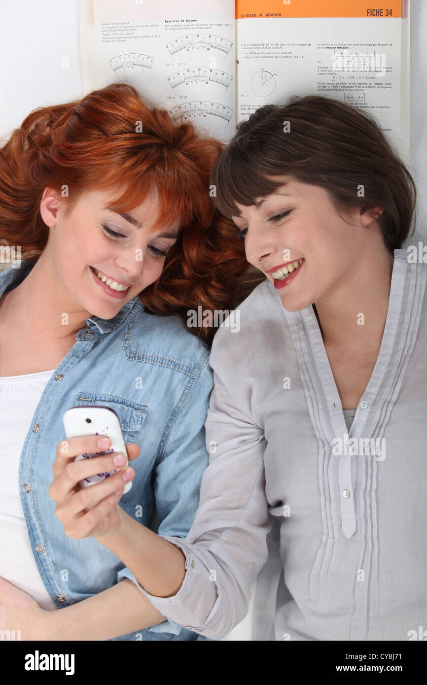 Girl laying down with mobile Stock Photo - Alamy