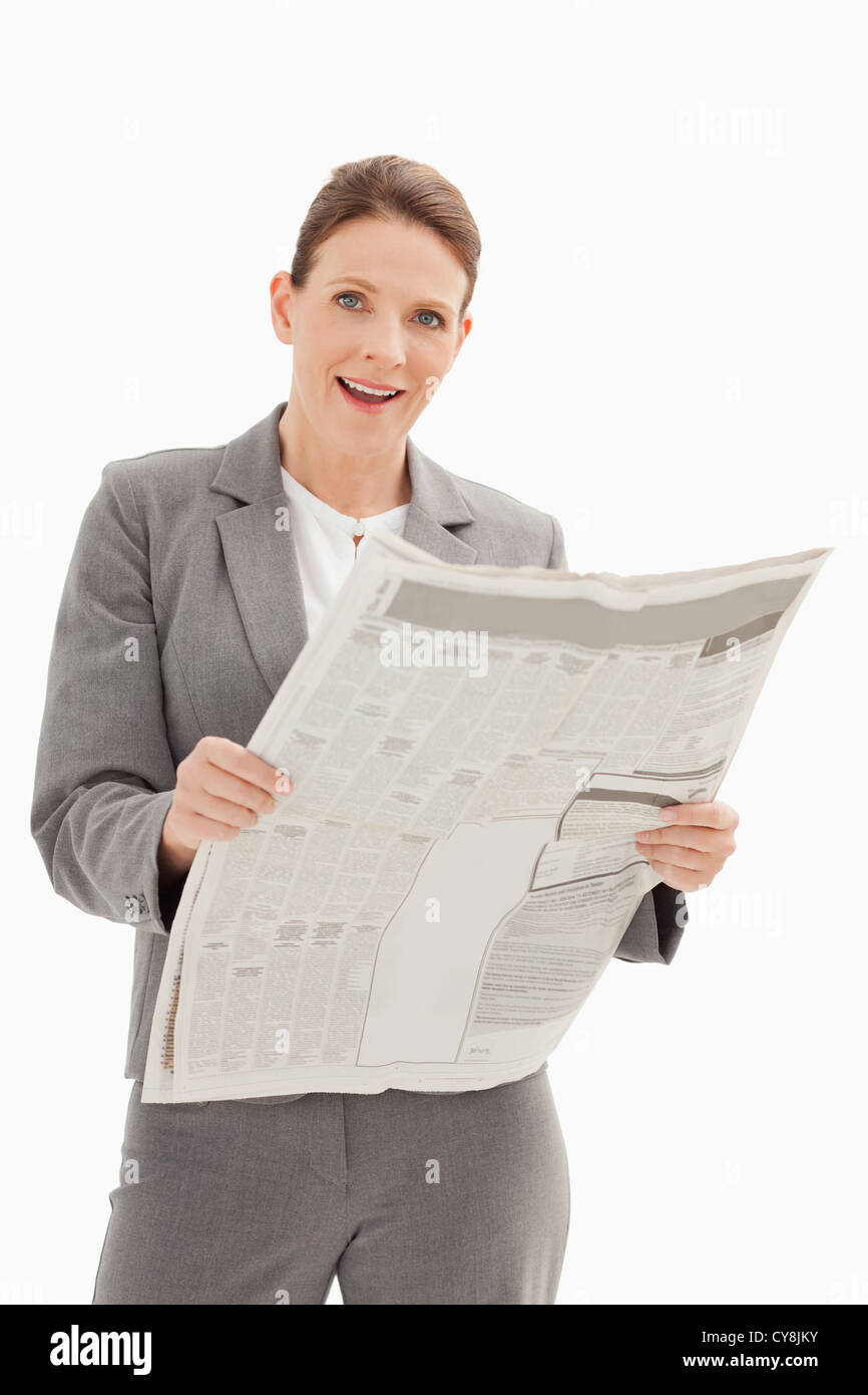 Surprised businesswoman holding newspaper Stock Photo - Alamy