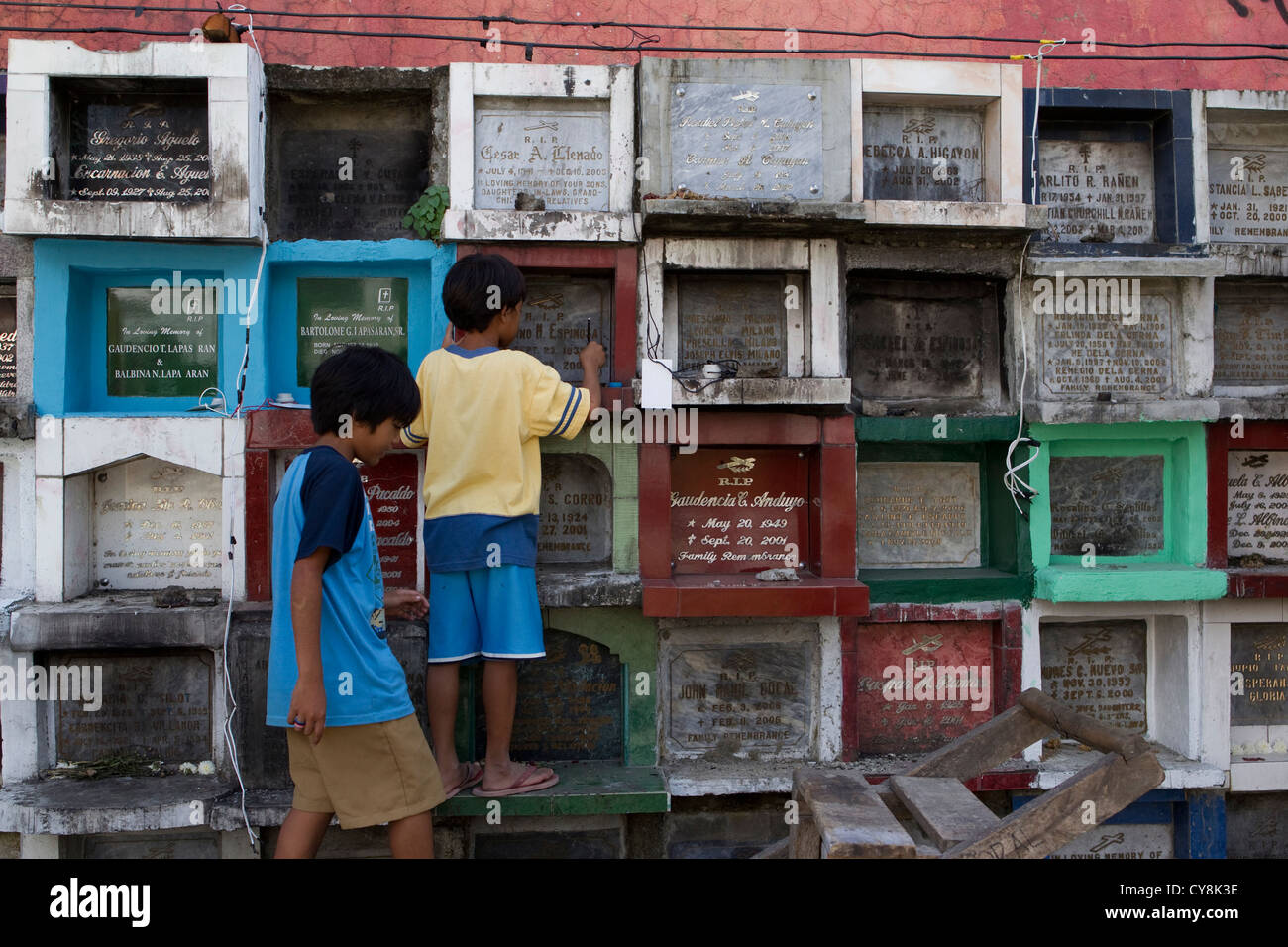 Young Filipino boy attends graveyard tombs,Carreta cemetery,Cebu ...