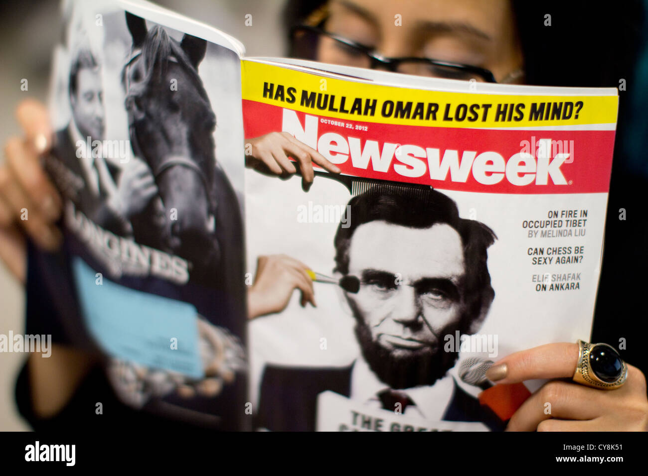 Reading a newsweek magazine hi-res stock photography and images - Alamy