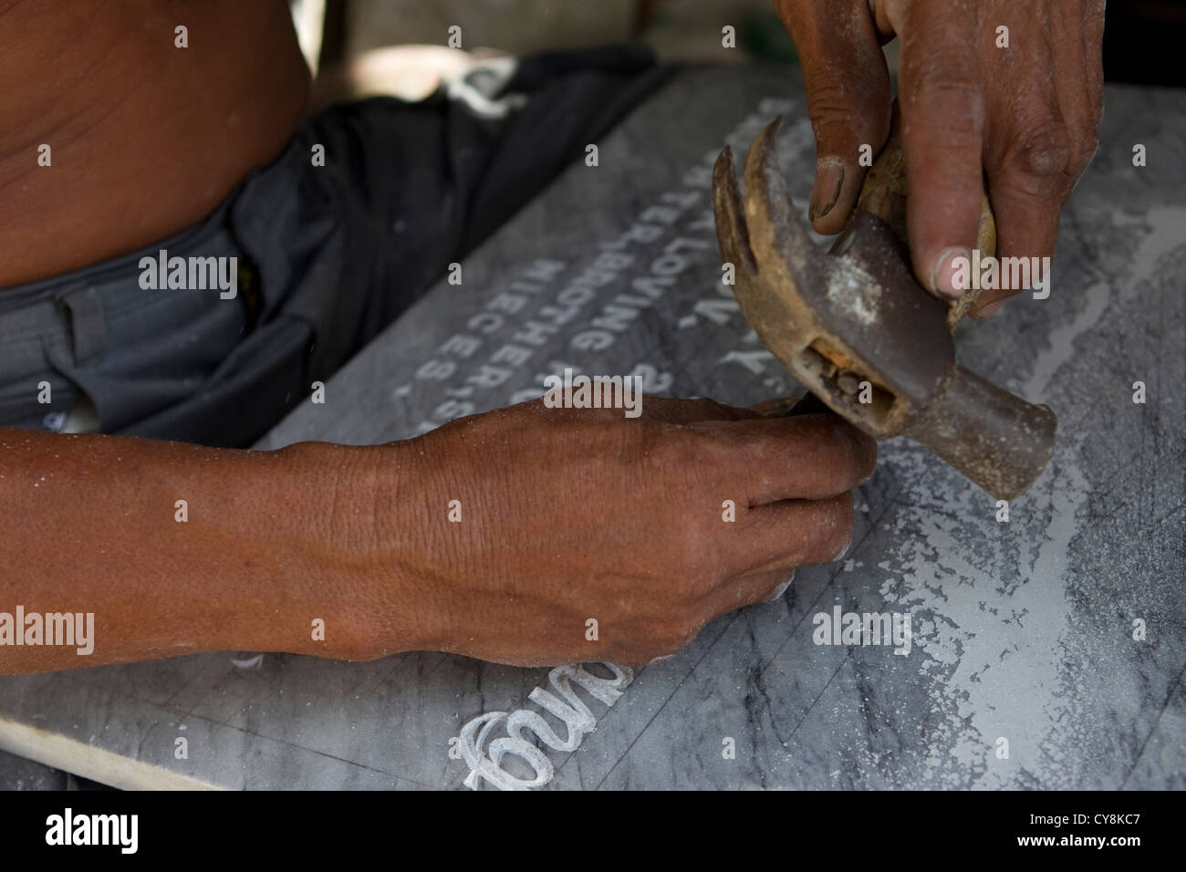 Filipino man engraves a headstone,Calamba cemetery;Cebu City ...