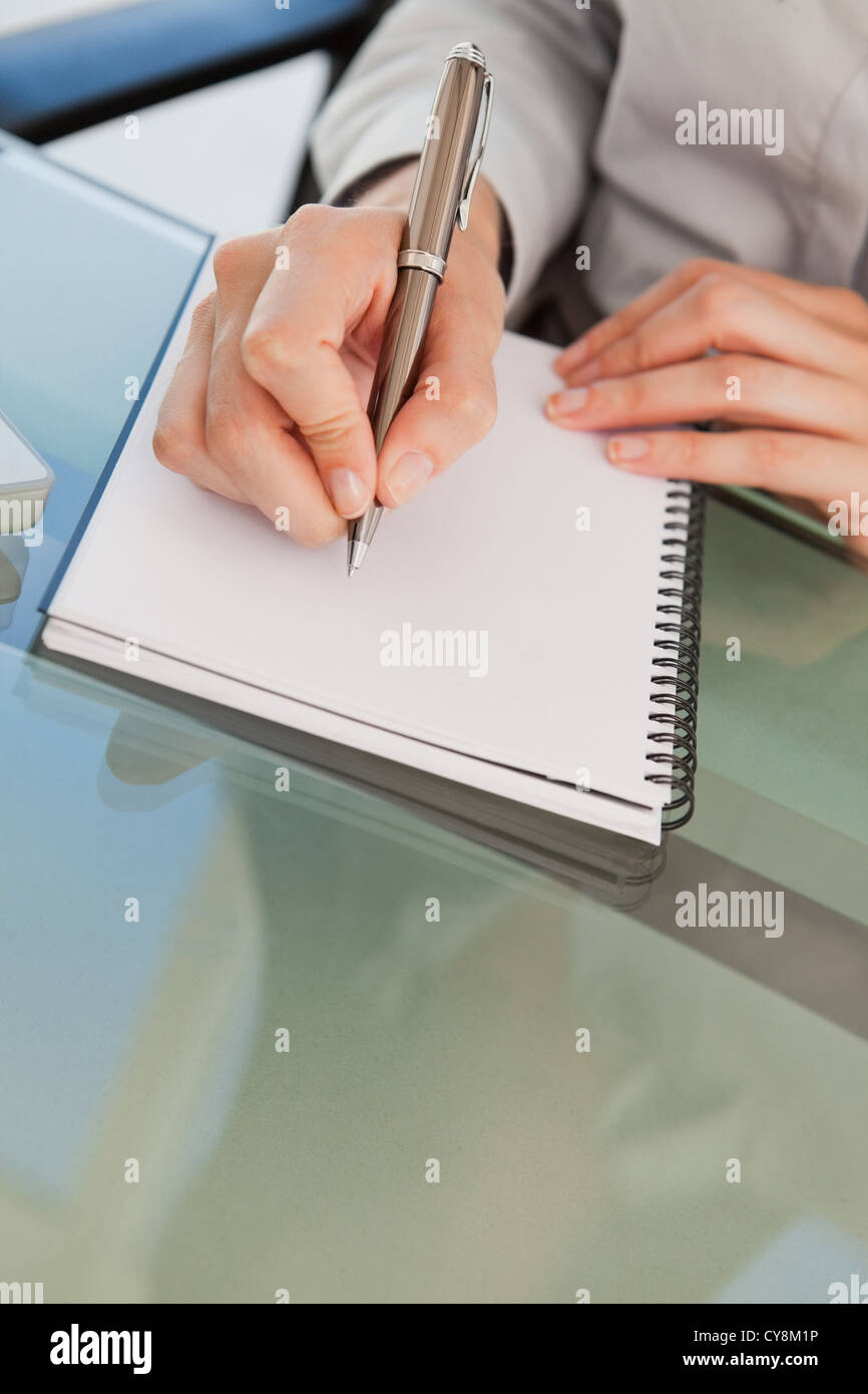 Close up of a woman jotting down some notes Stock Photo - Alamy