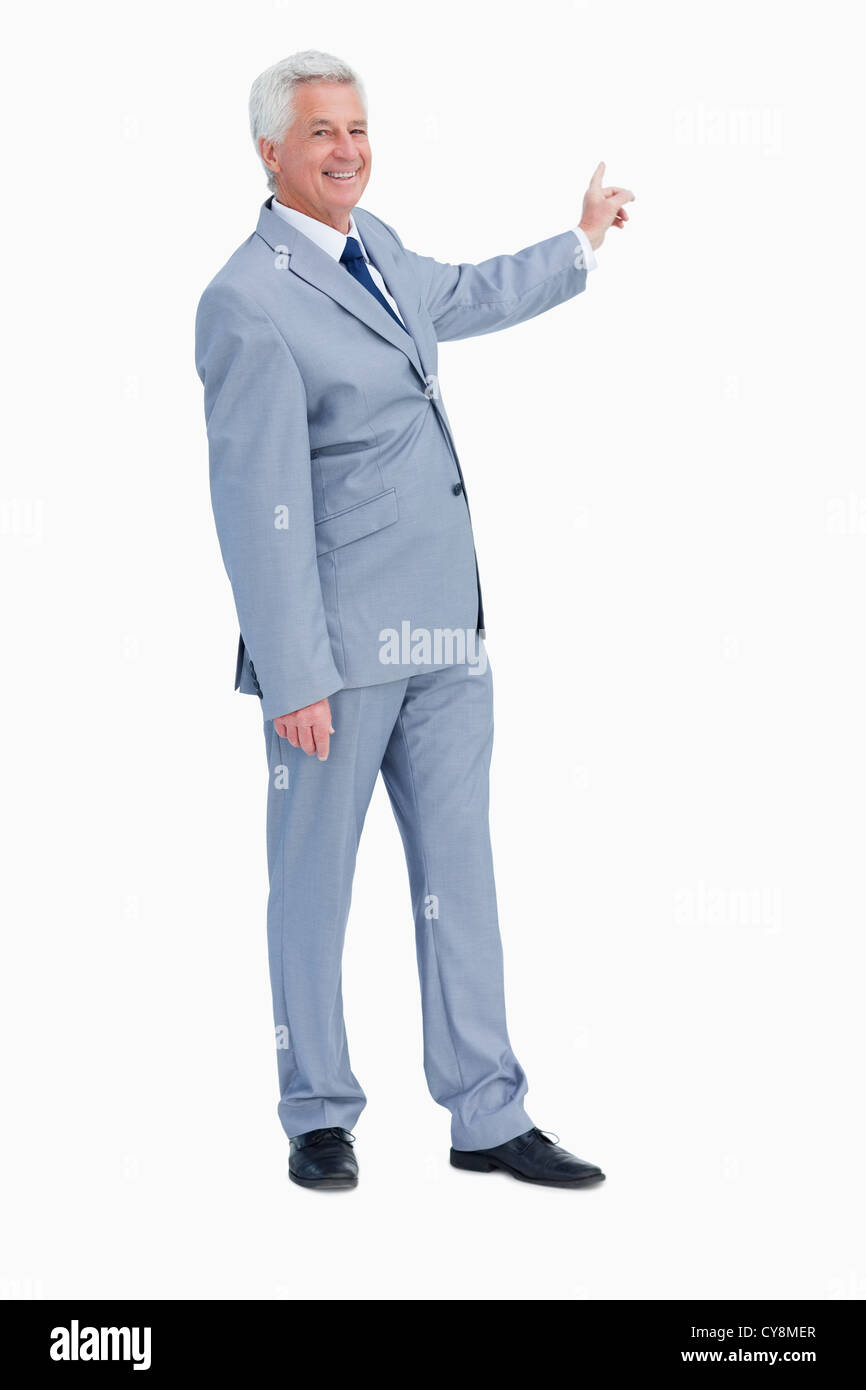 Portrait of a businessman pointing behind him Stock Photo - Alamy