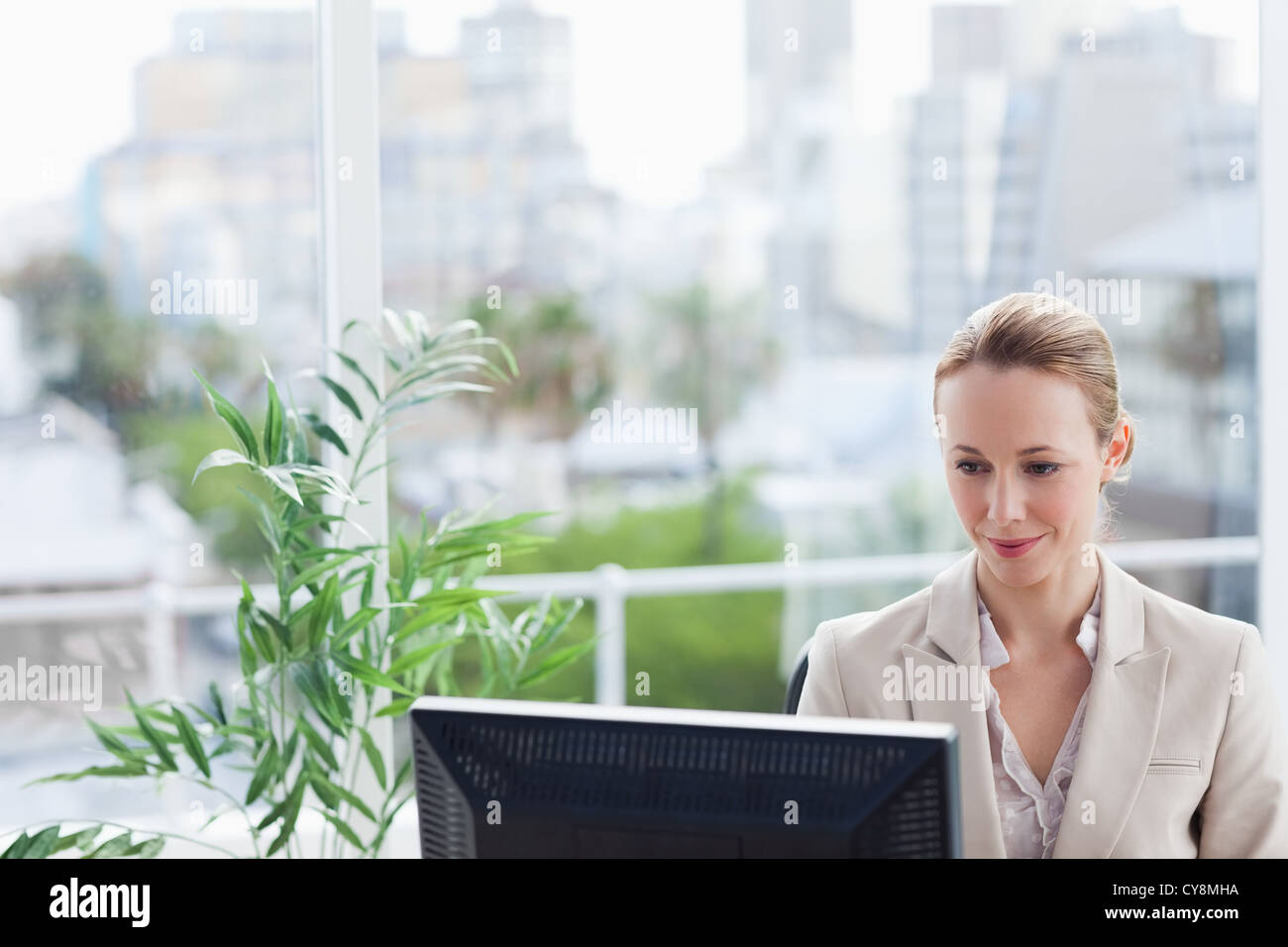 Woman working on a computer Stock Photo - Alamy