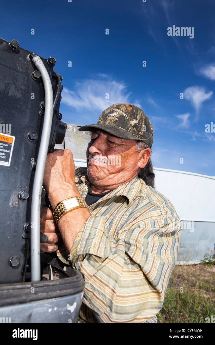 Louis Ladouceur fixing his outboard motor, a first nation resident of ...