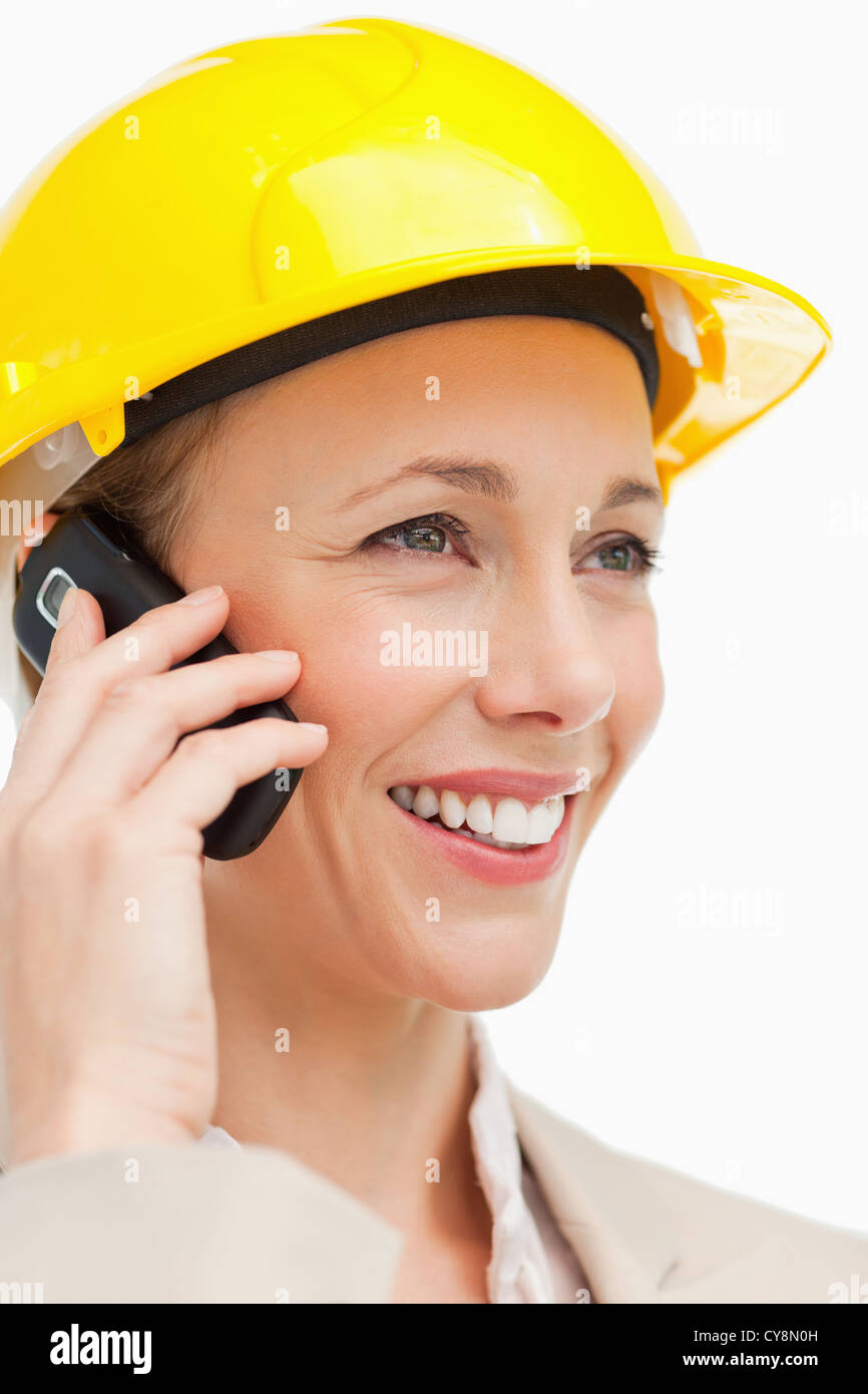 Close-up of a woman wearing safety helmet while talking on the phone ...