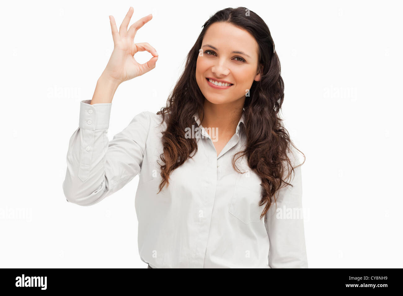 Portrait of a brunette woman showing the okay sign Stock Photo - Alamy