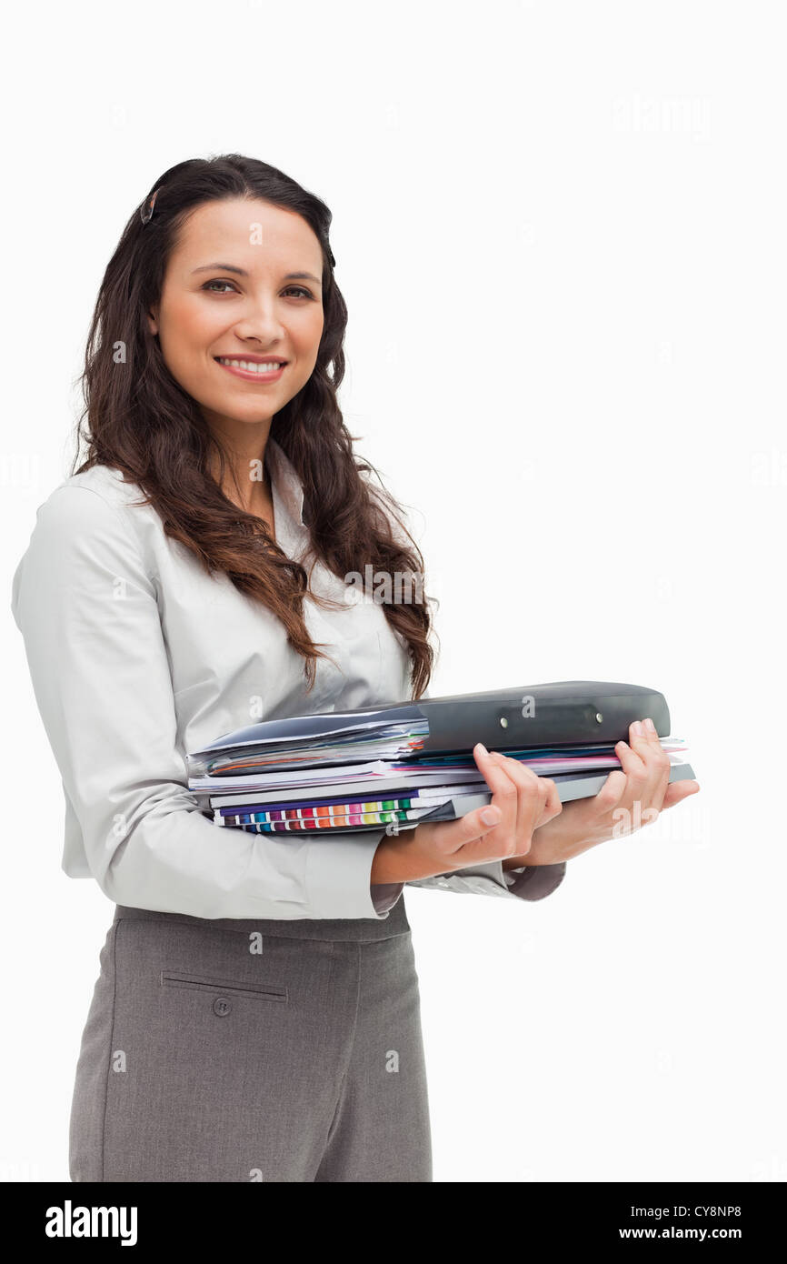 Portrait of a brunette woman carrying a lot of files Stock Photo - Alamy