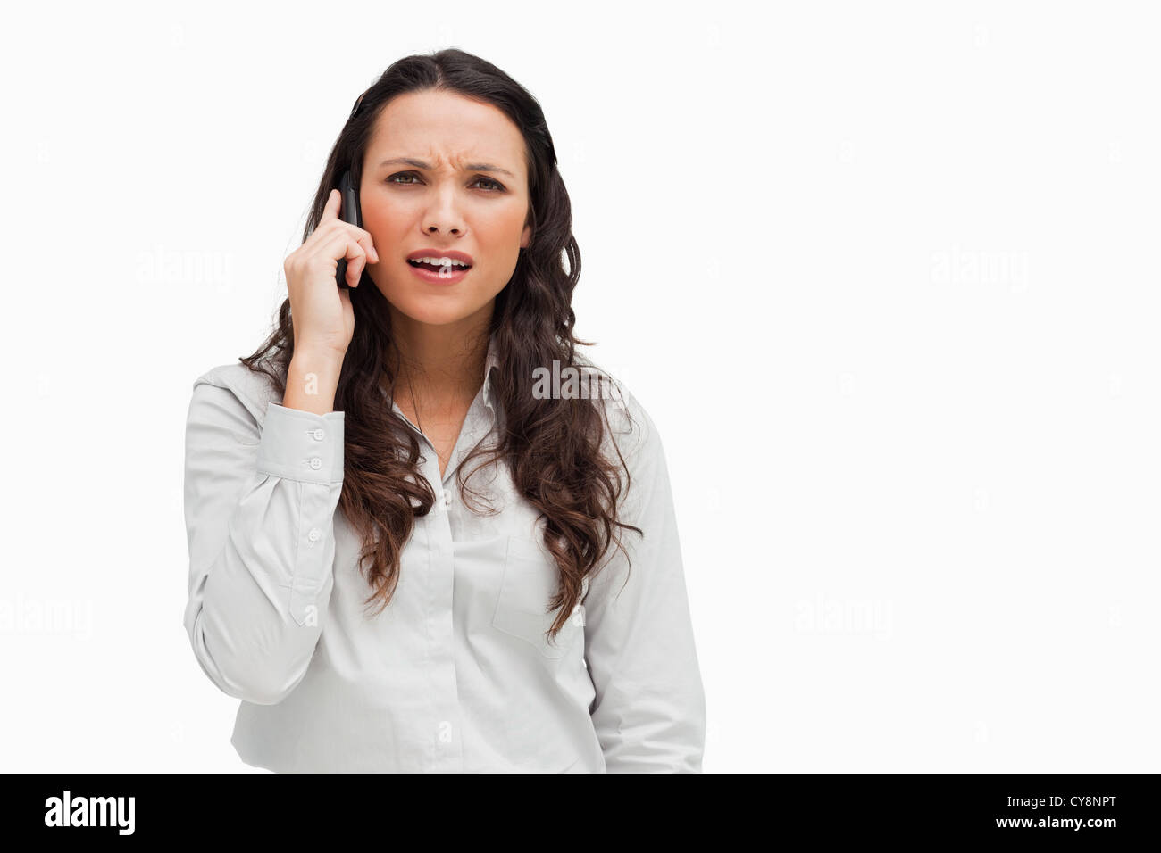 Brunette woman listening to her mobile phone Stock Photo - Alamy