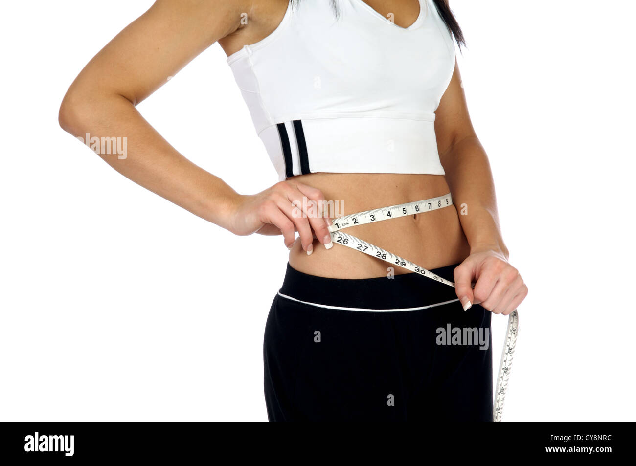 Young woman measuring her waist with a tape measure Stock Photo - Alamy