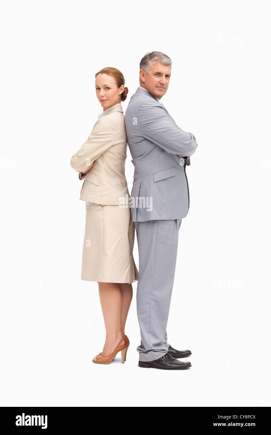 Portrait of business people standing back to back Stock Photo - Alamy
