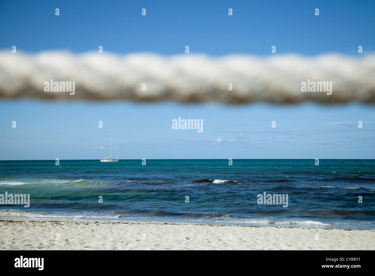 Beach scene, rope in foreground Stock Photo - Alamy