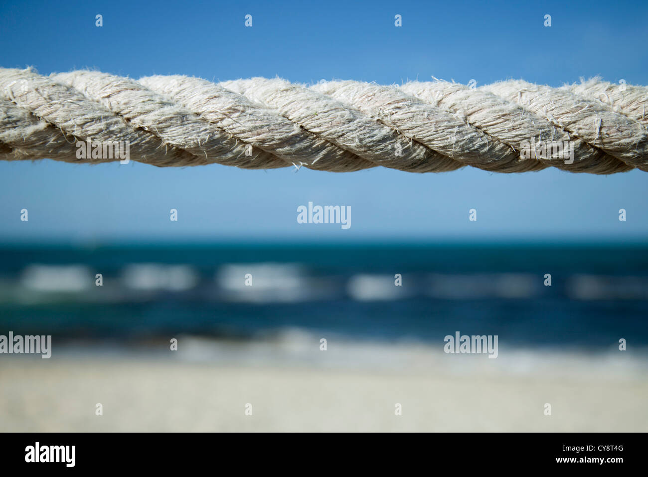 Close-up of weathered rope with beach in background Stock Photo - Alamy