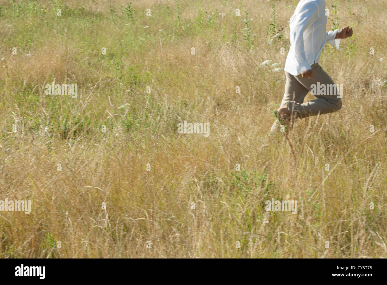 Man running through field, mid section Stock Photo - Alamy