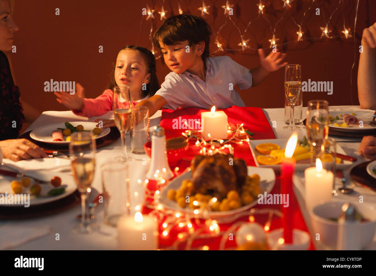 Little boy and little girl playing during Christmas dinner Stock Photo ...