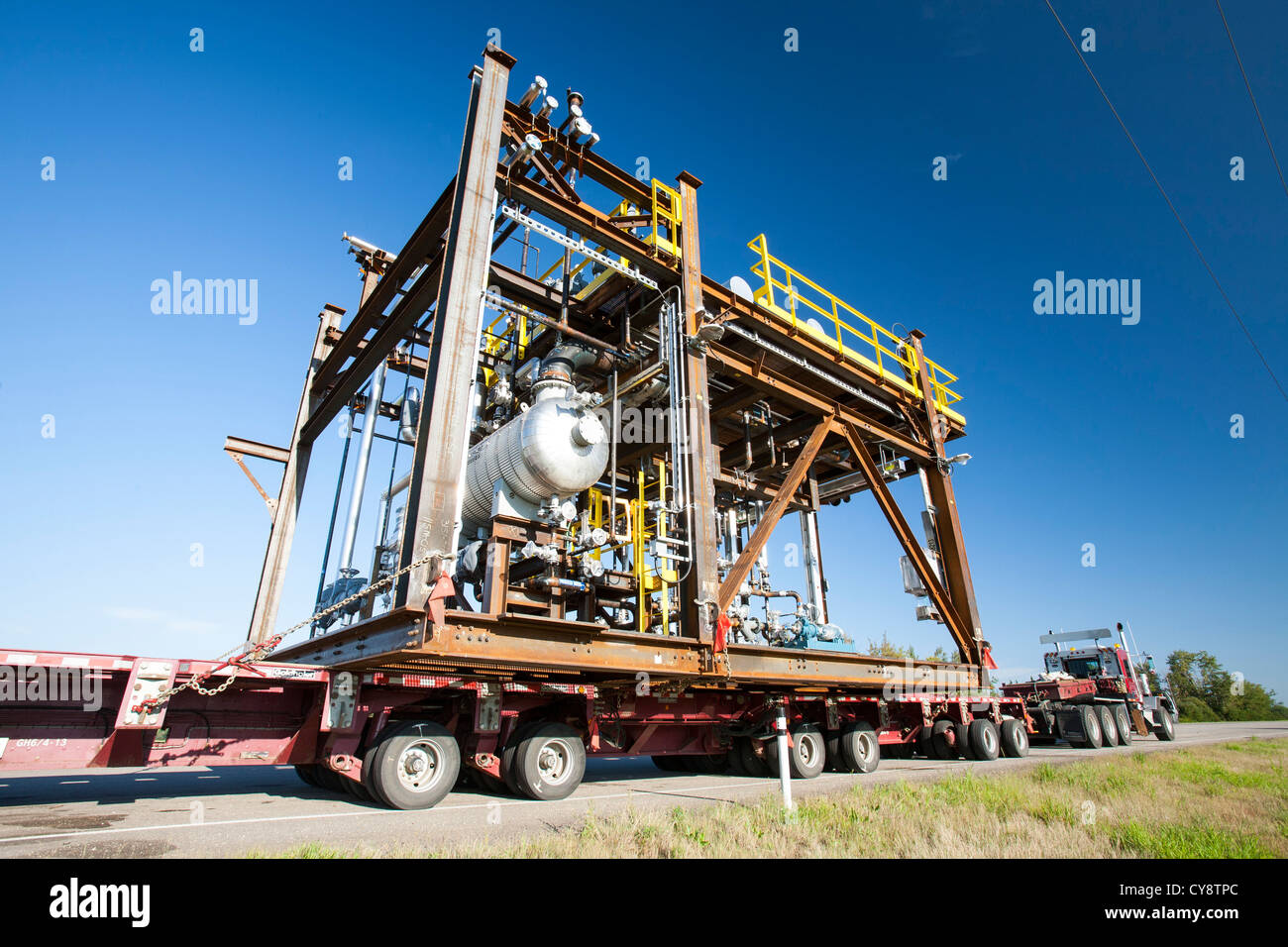 Trucks haul an oversize load of tar sands equipment for a SAG D mine ...