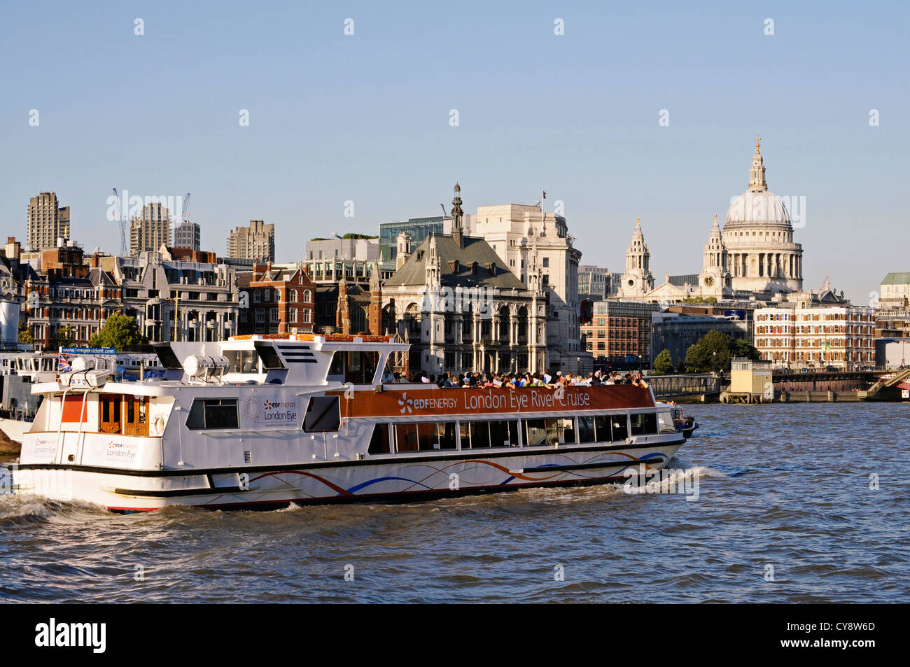 London River Thames cruise boat with St Pauls in the background at dusk ...