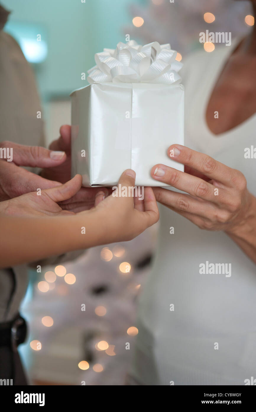 Man, woman and child's hands holding gift together, cropped Stock Photo ...