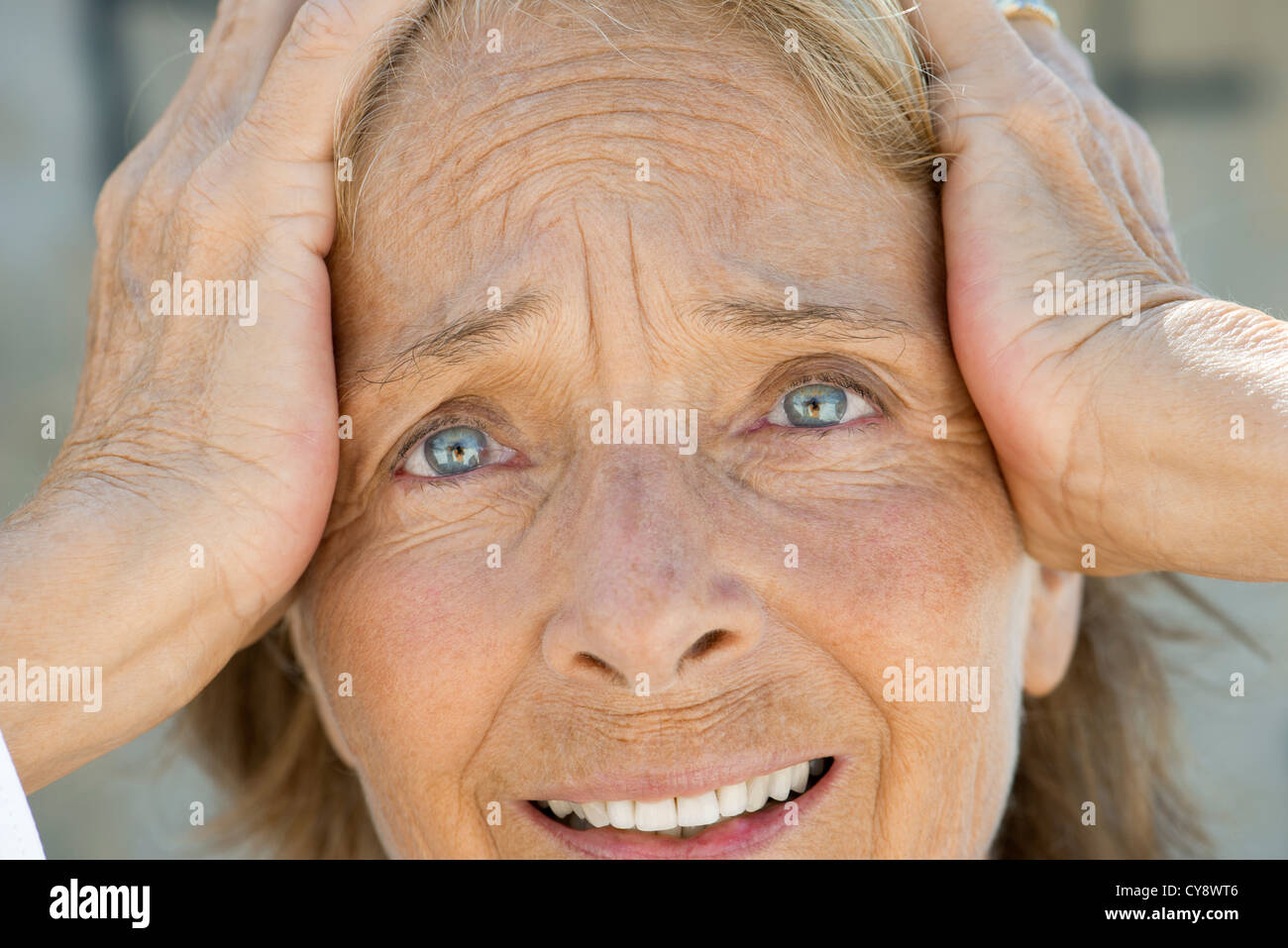 Senior woman holding head, distressed expression on face Stock Photo ...