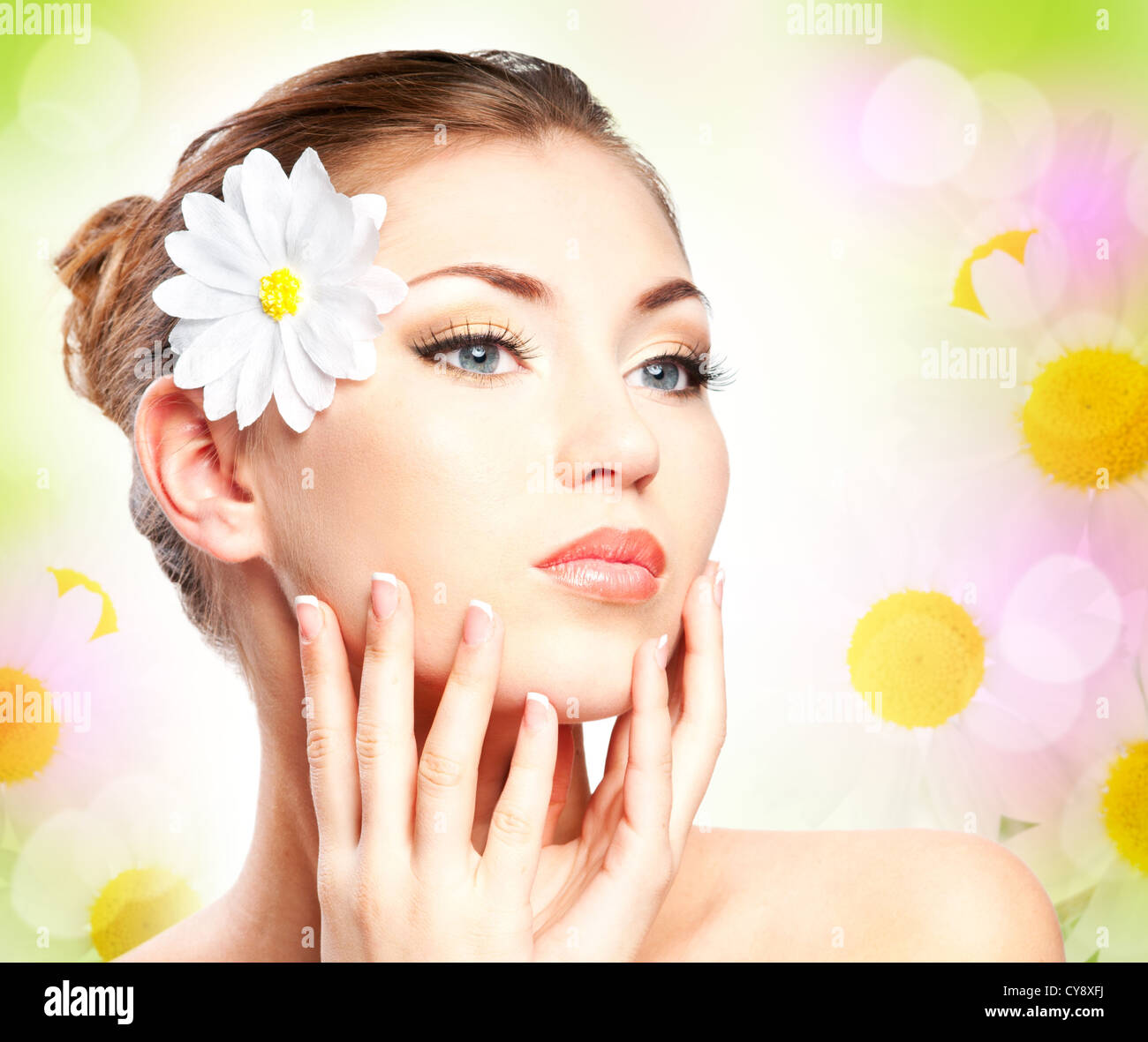 Spa (spring) beautiful girl with camomile touching her face Stock Photo ...