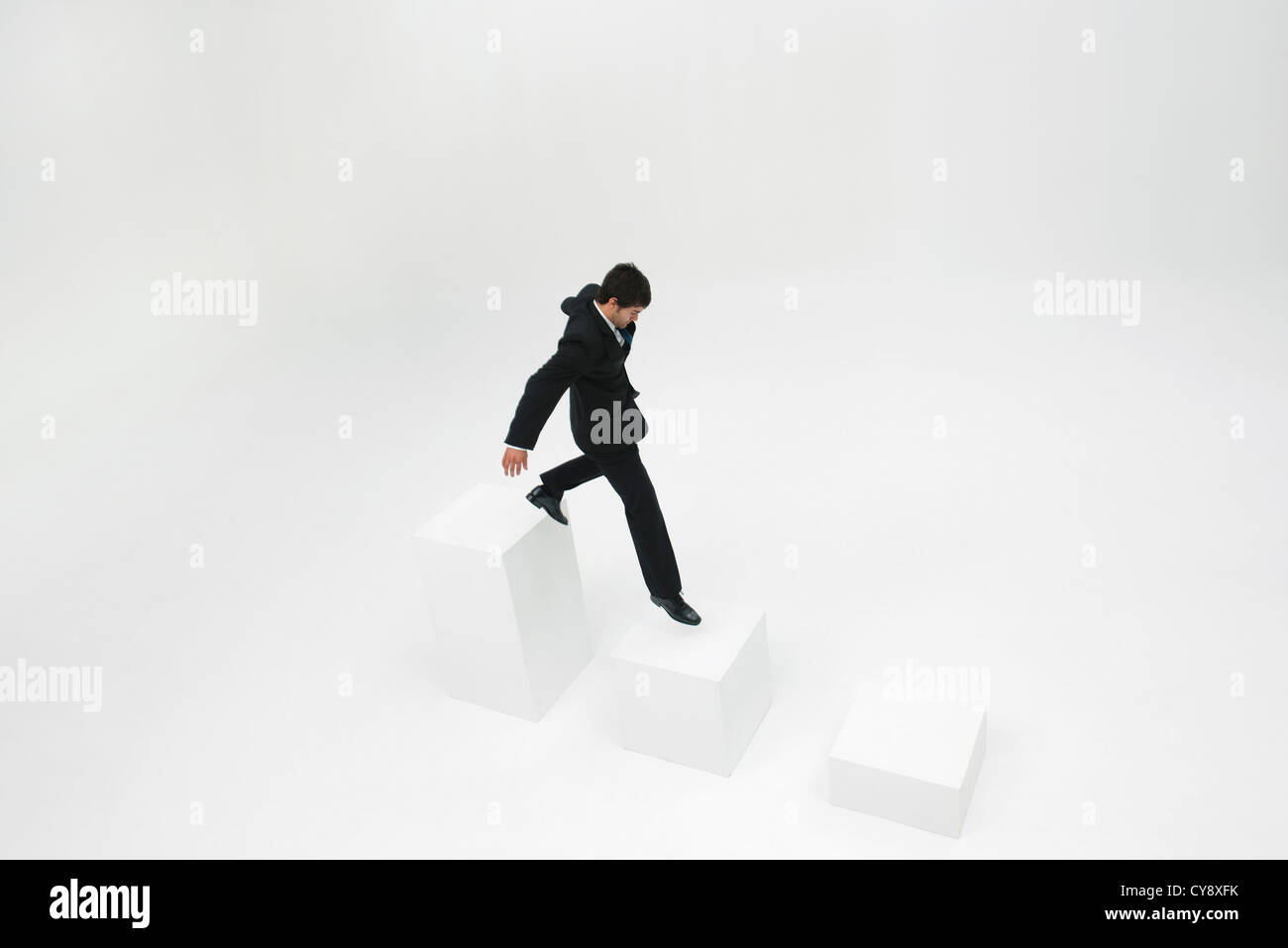 Businessman descending steps Stock Photo - Alamy
