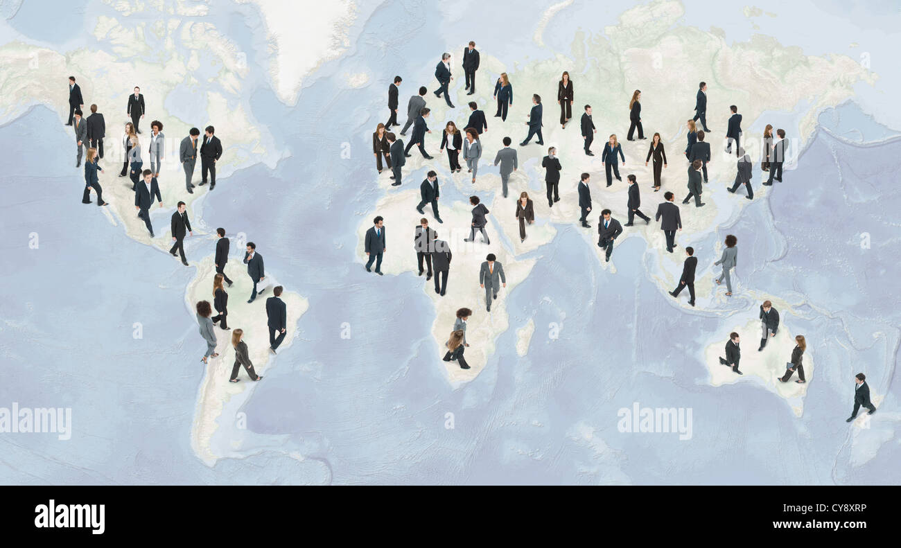 Large group of executives walking on world map Stock Photo - Alamy