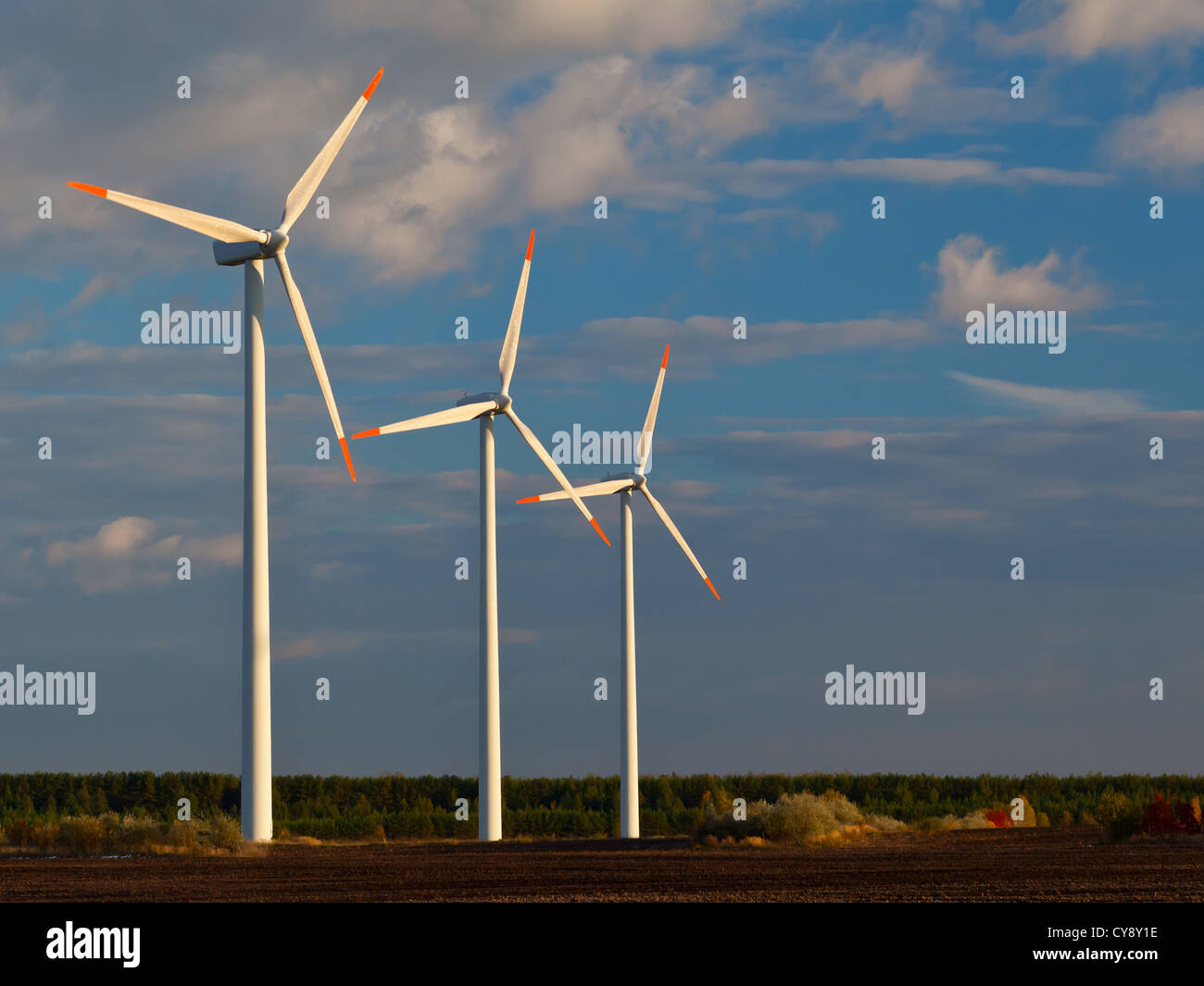 Windmill power generators at sunset with blue sky Stock Photo - Alamy