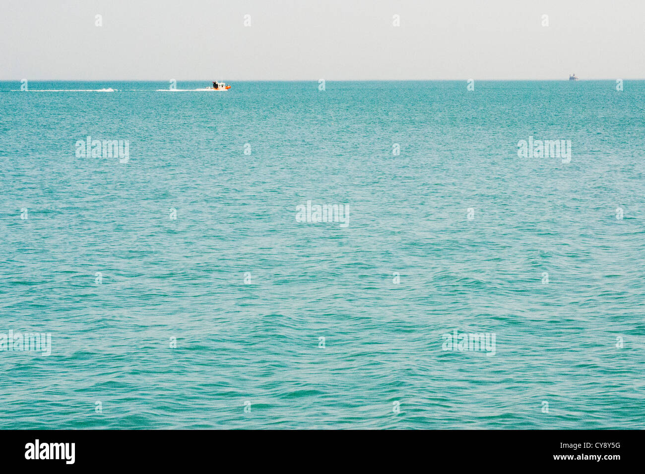 Boat and its wake lake michigan Stock Photo - Alamy
