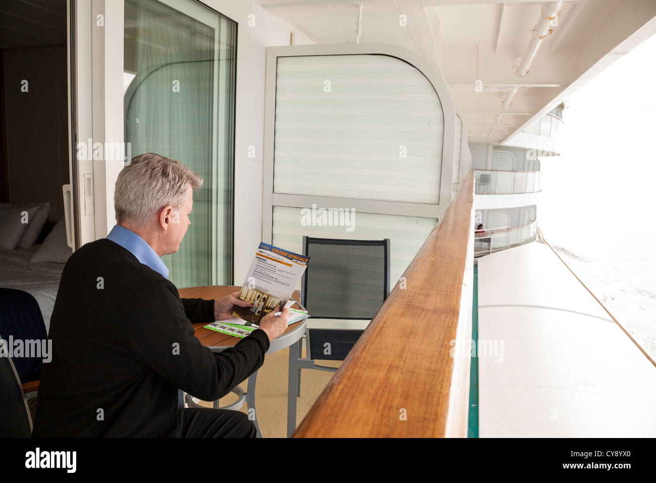 Mature Man Reading Aboard Cruise Ship Stock Photo - Alamy