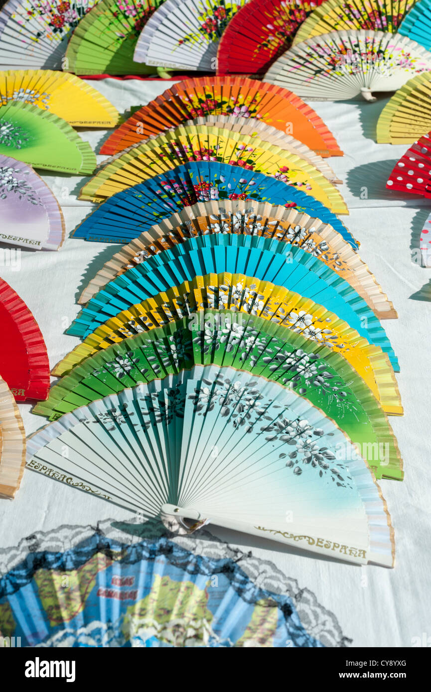 Brightly coloured fans for sale in a market at Puerto de Mogan Gran ...