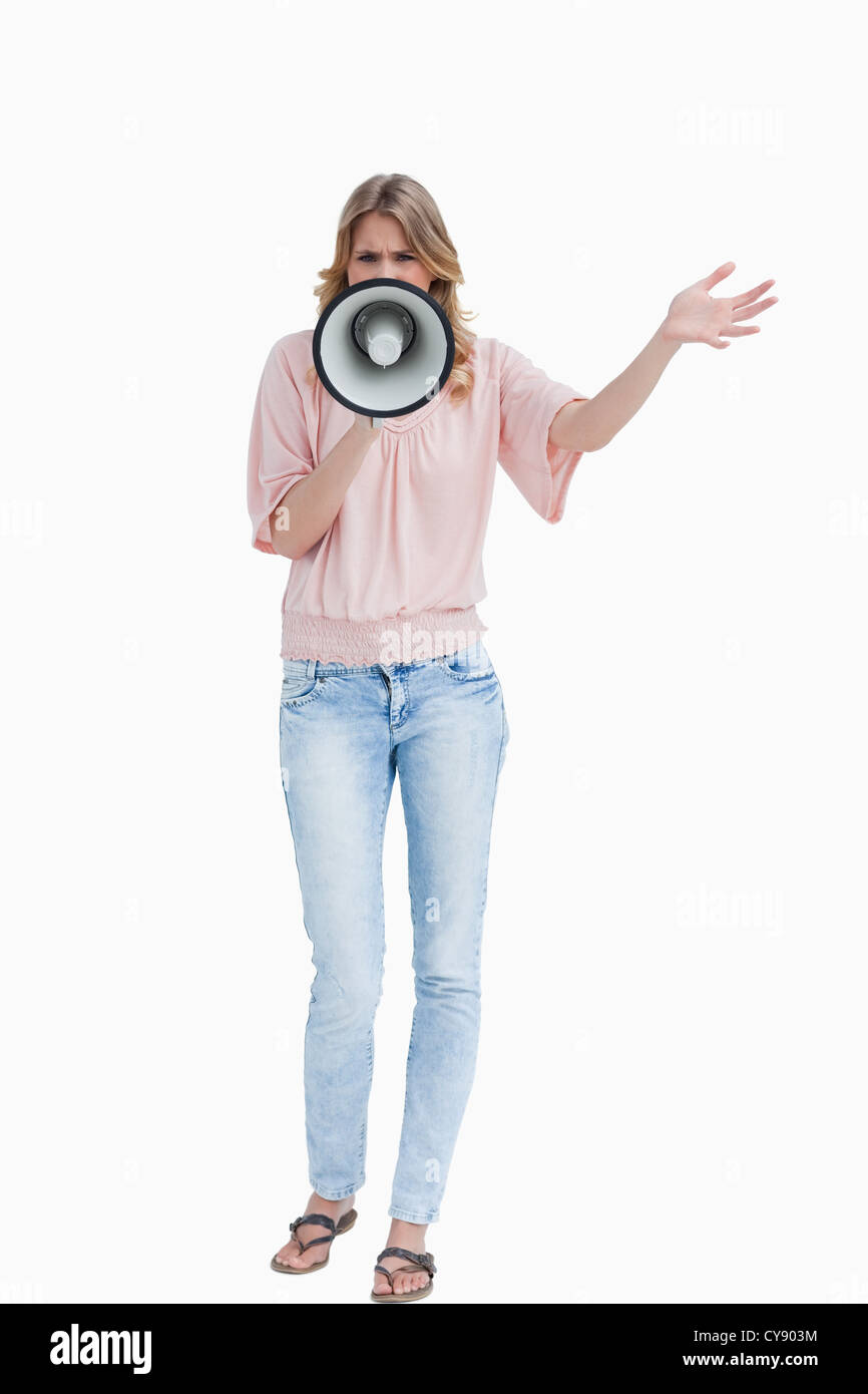 Young woman standing upright while using a megaphone Stock Photo - Alamy