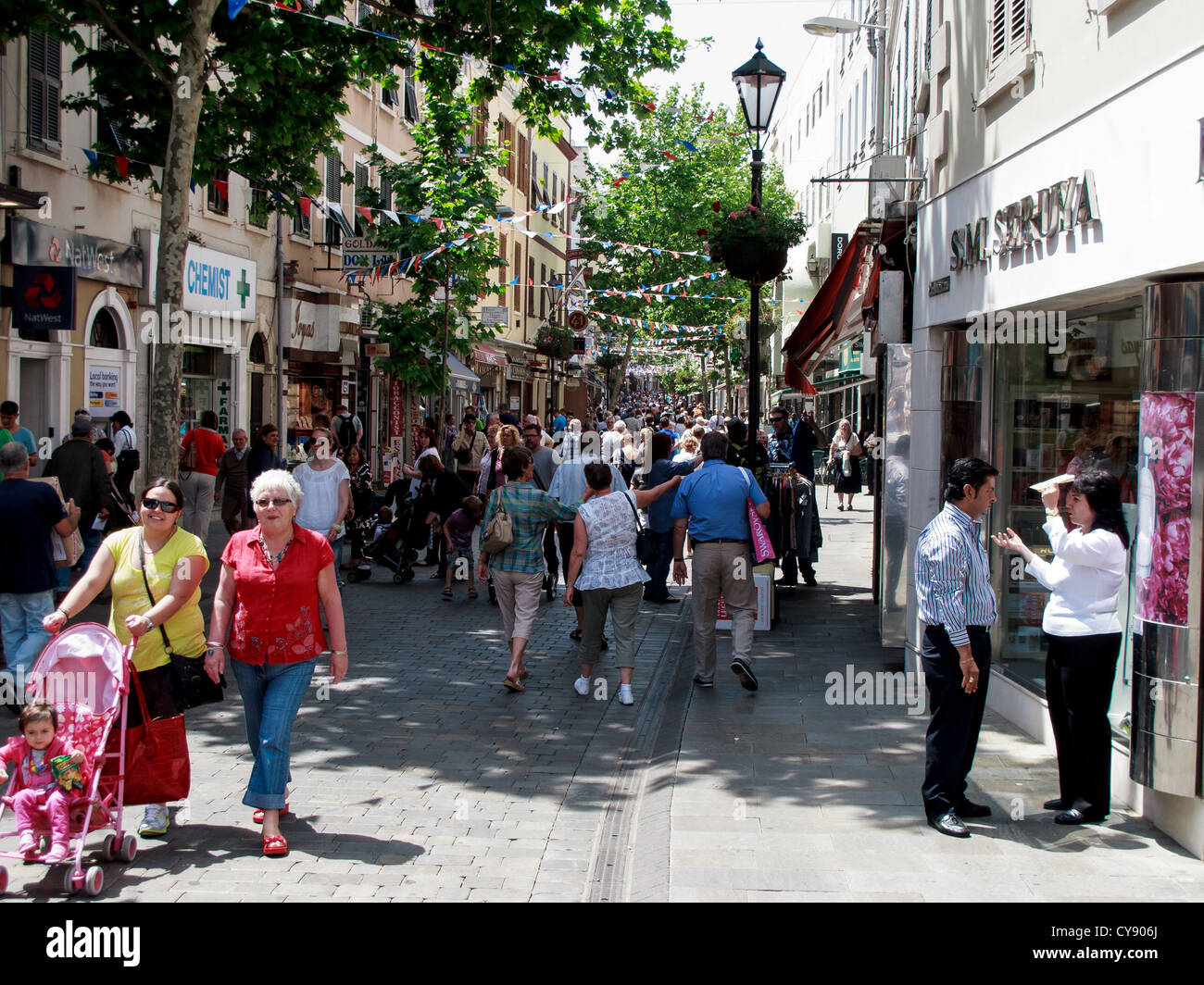 Tourists walking down main street Stock Photo - Alamy