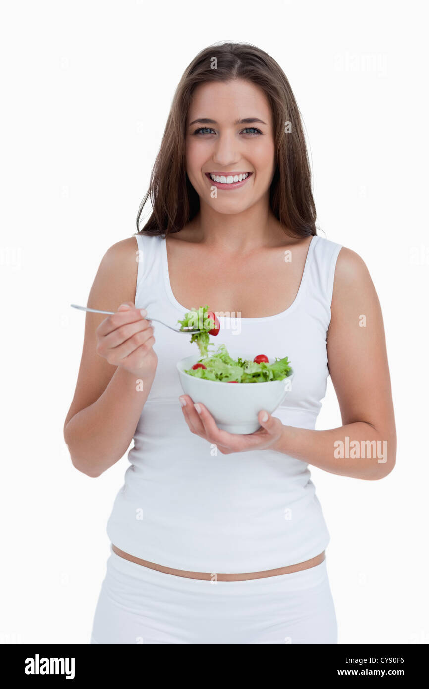 Smiling woman eating a salad Stock Photo - Alamy