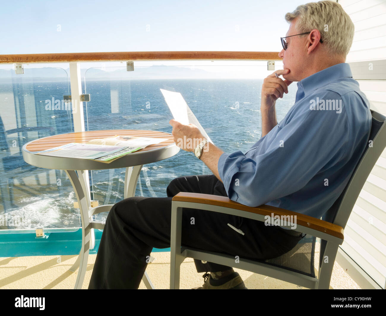 Mature Man Reading Aboard Cruise Ship Stock Photo - Alamy
