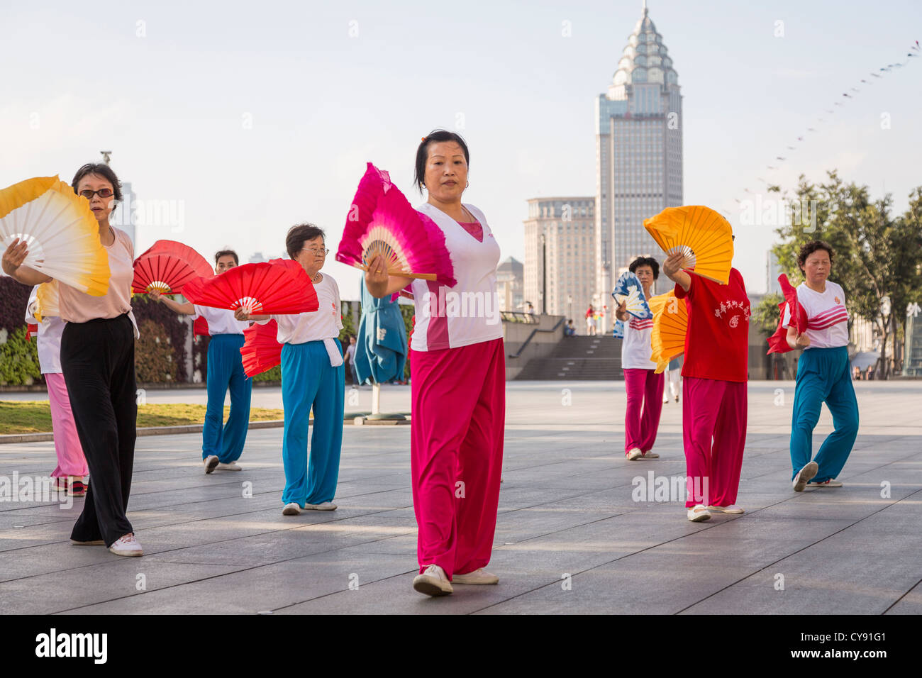 Chinese women perform early morning fan exercise on the Bund Shanghai ...