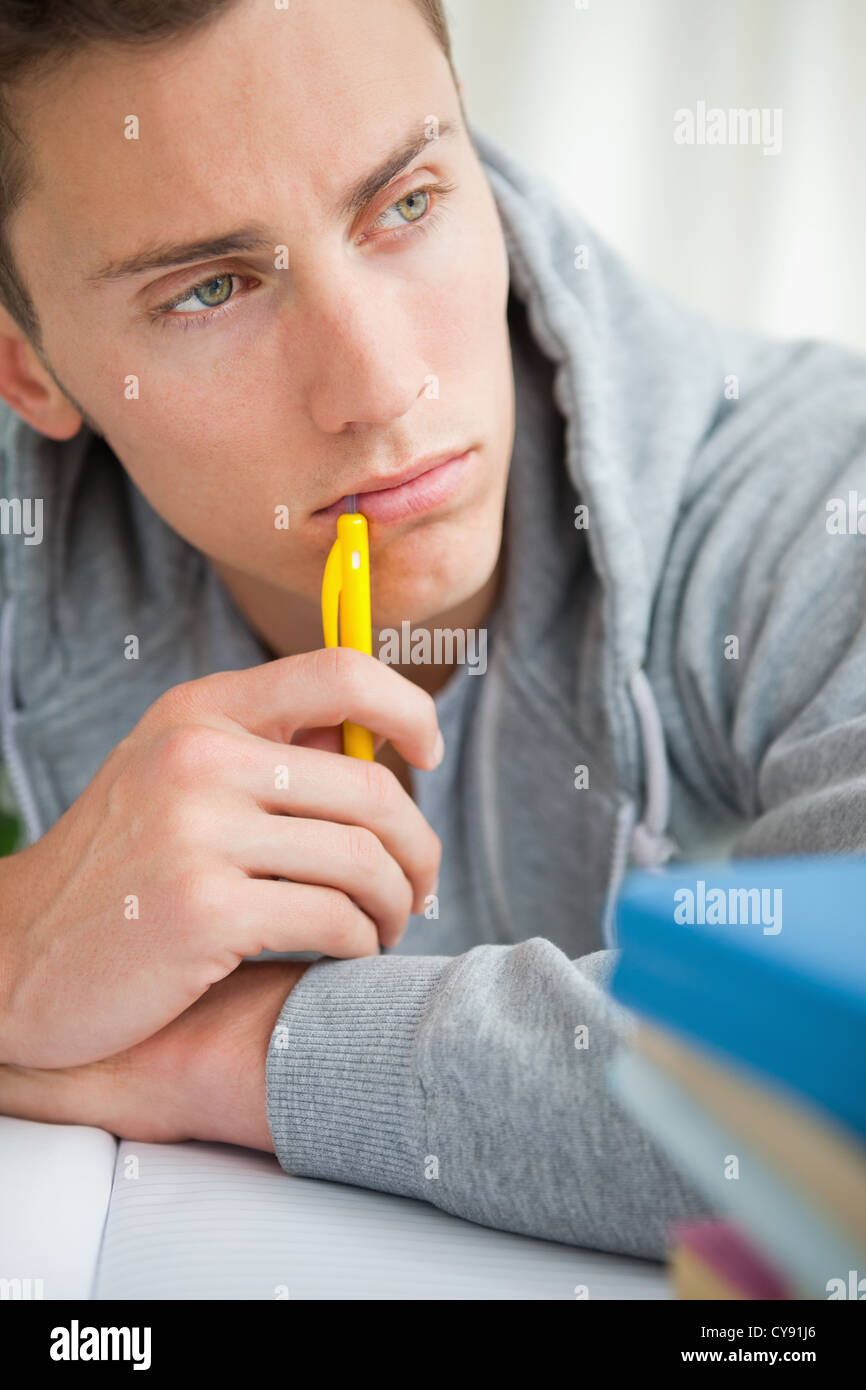 Close-up of a depressed student chewing his pencil Stock Photo - Alamy