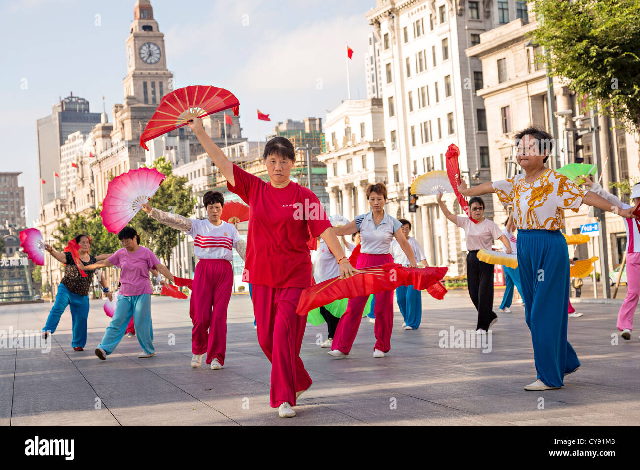 Chinese women perform early morning fan exercise on the Bund Shanghai ...